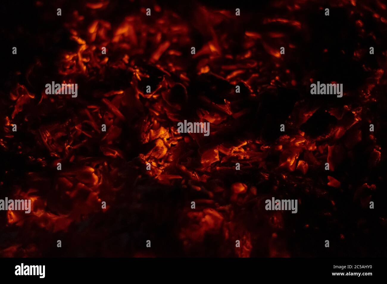 Closeup of embers of a burning log creating a fiery background Stock ...