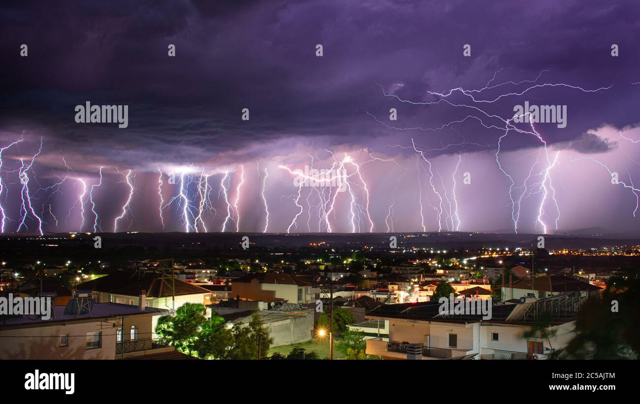 Lightning and lightning in a storm in front of a village Stock Photo ...