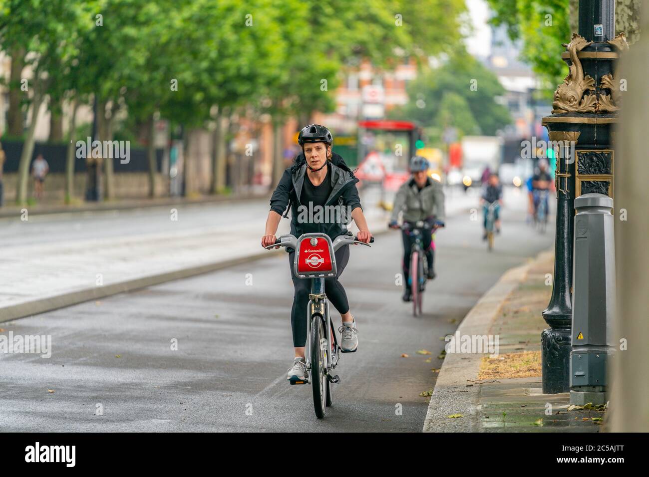 LONDON, ENGLAND - JUNE 10, 2020: Beautiful young woman cyclist wearing ...
