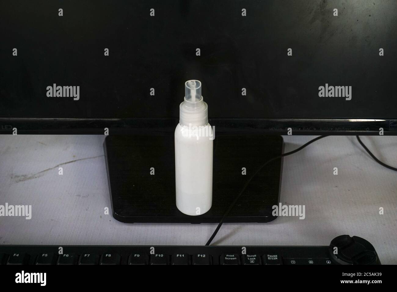 High angle shot of a bottle of sanitizer by the monitor and the ...