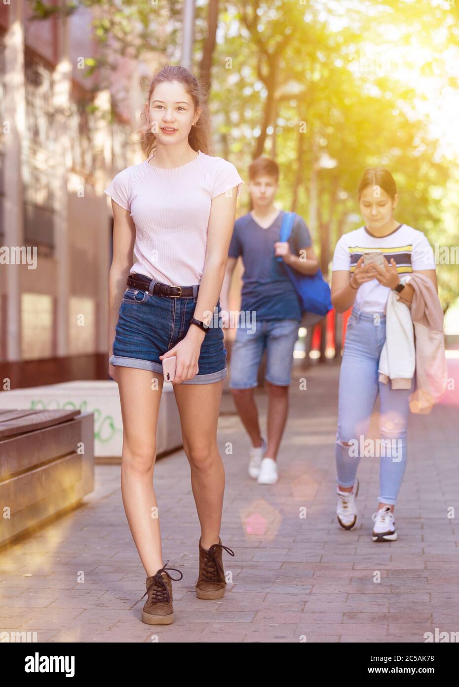 Full length portrait of modern teen girl dressed in white tee shirt and ...