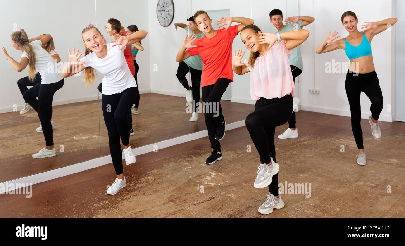 Teenage dancers practicing active vigorous dance in modern studio Stock ...