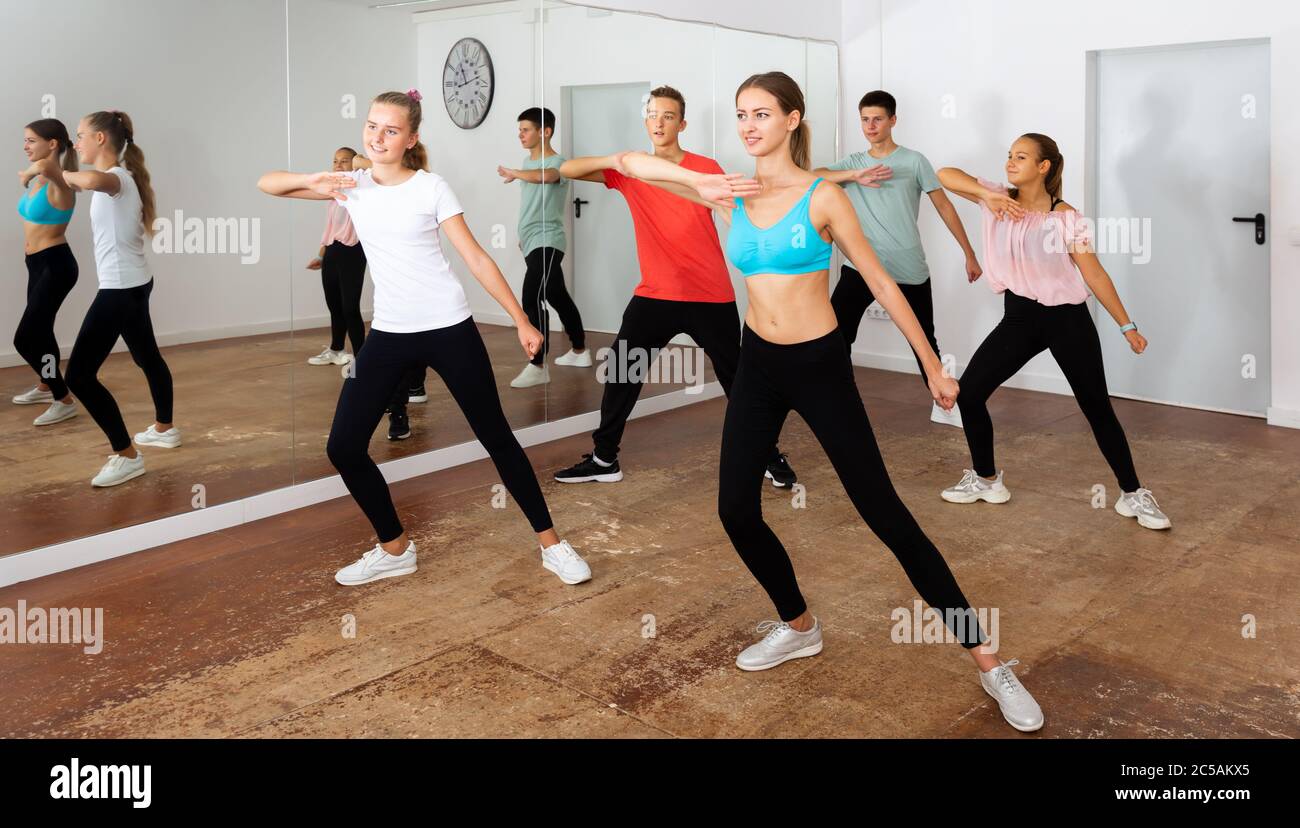 Friendly teenage boys and girls dancing synchronous group choreography ...