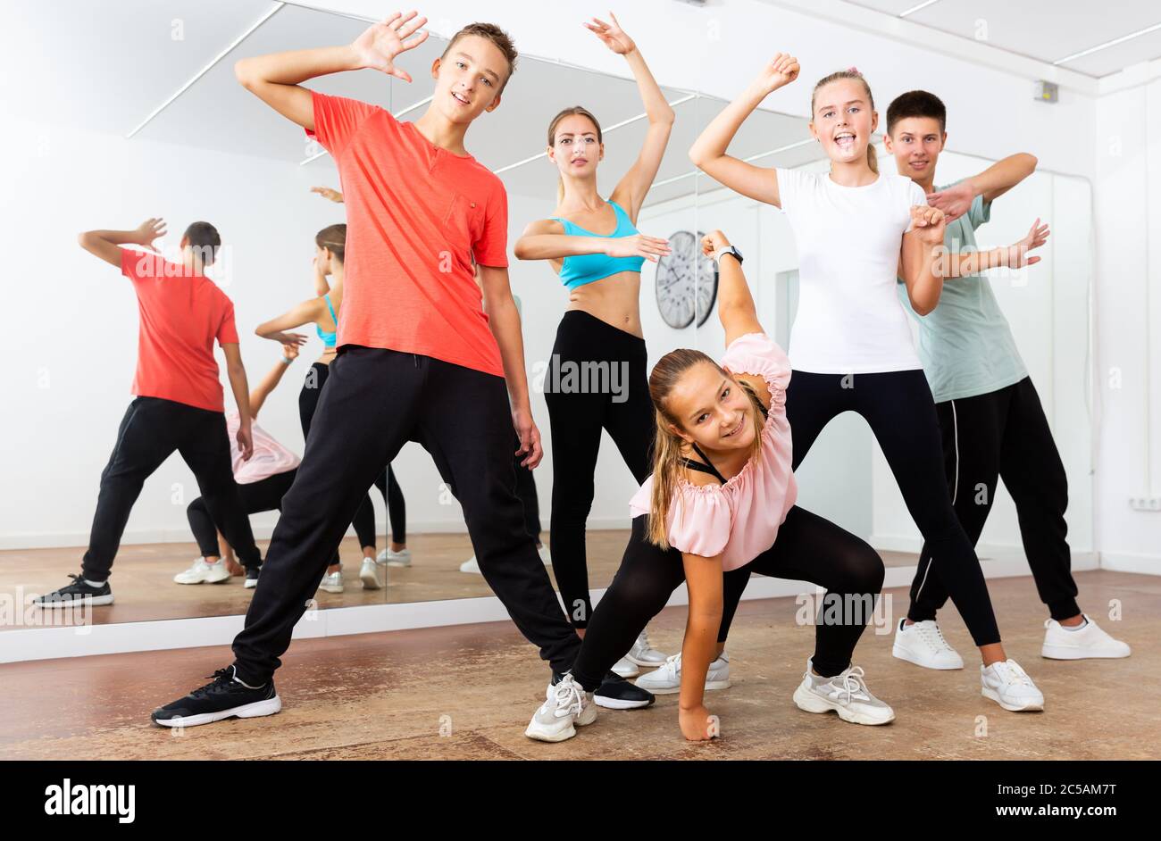 Group portrait of lucky teenagers with young female choreographer in ...