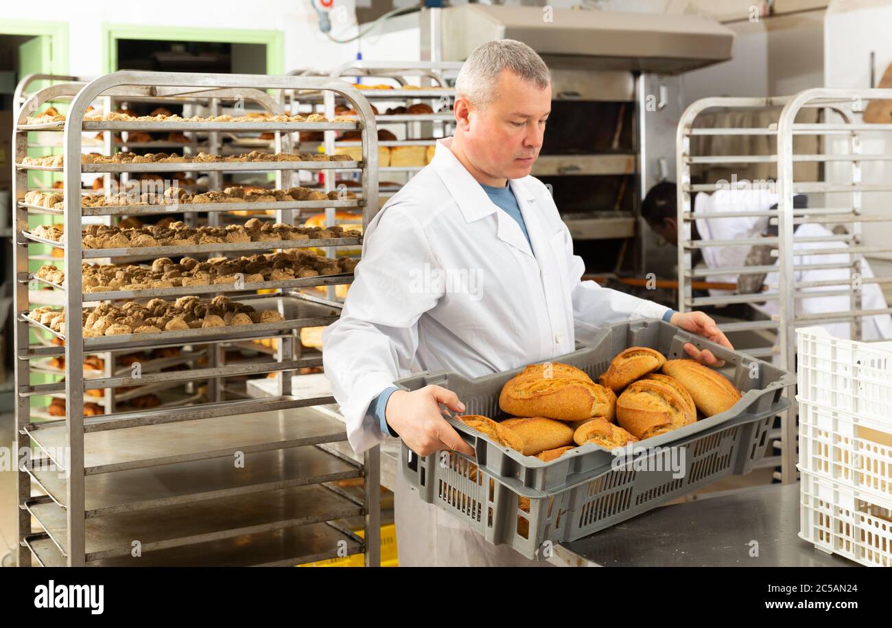 Successful baker during daily work in bakeshop Stock Photo - Alamy