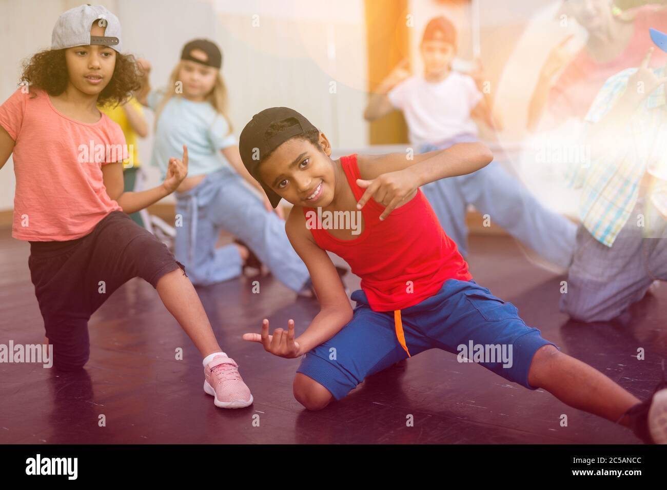 Portrait of african boy and girl training hip hop movements during ...