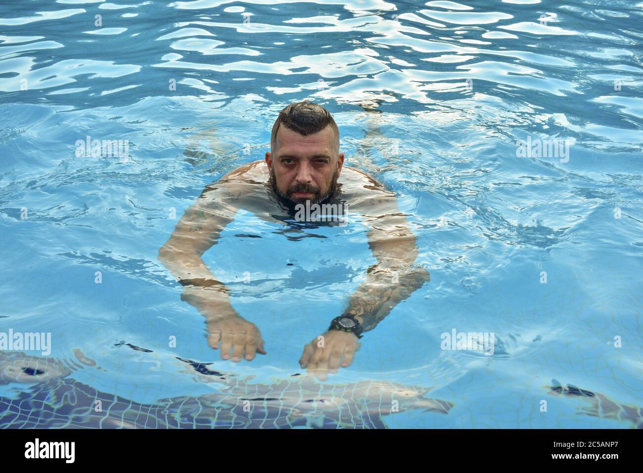 Bearded man swimming in a pool. Man with a beard in the pool Stock ...