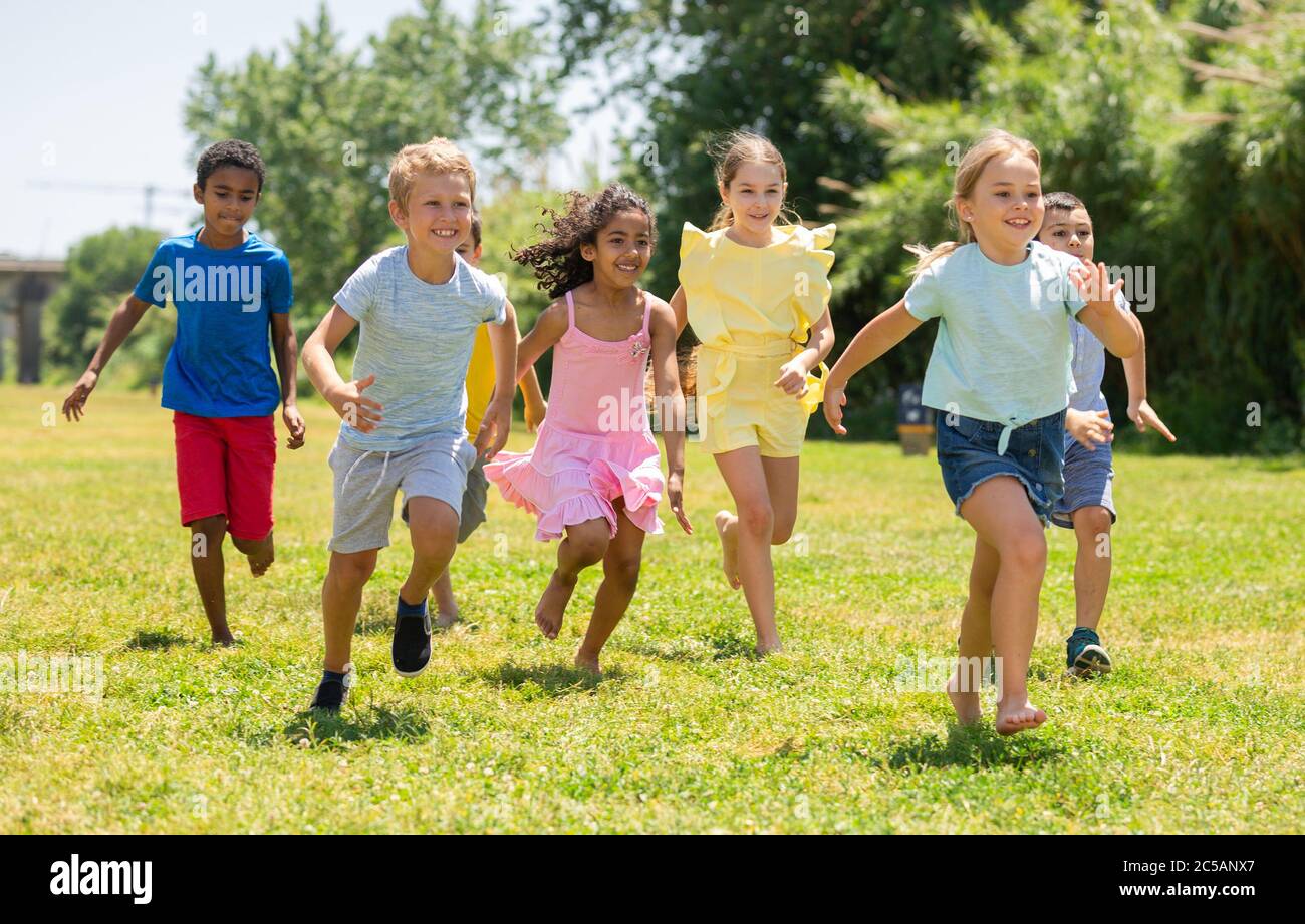 Cheerful kids are jogging together in the park and having fun Stock ...