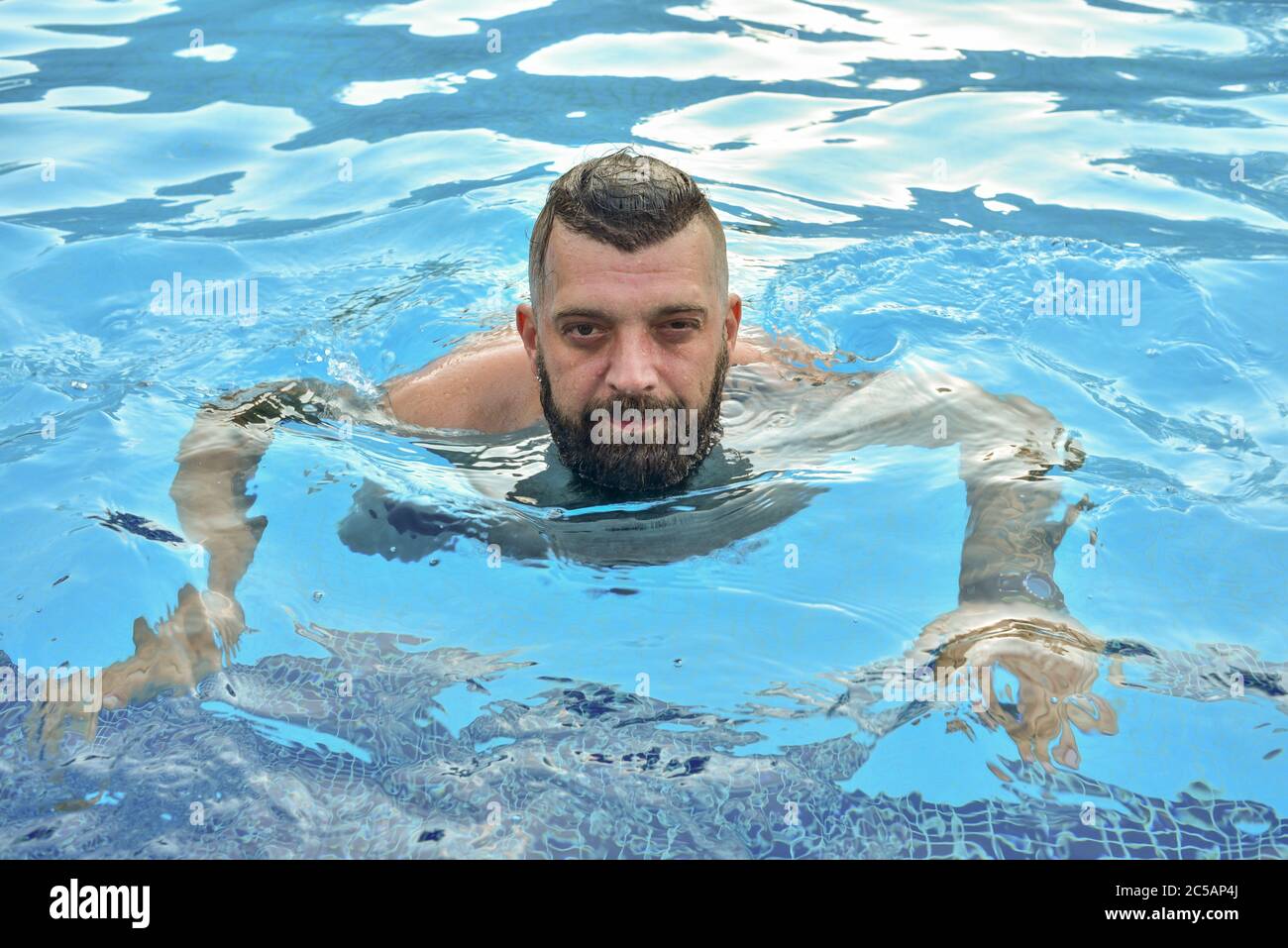 Bearded man swimming in a pool. Man with a beard in the pool Stock ...
