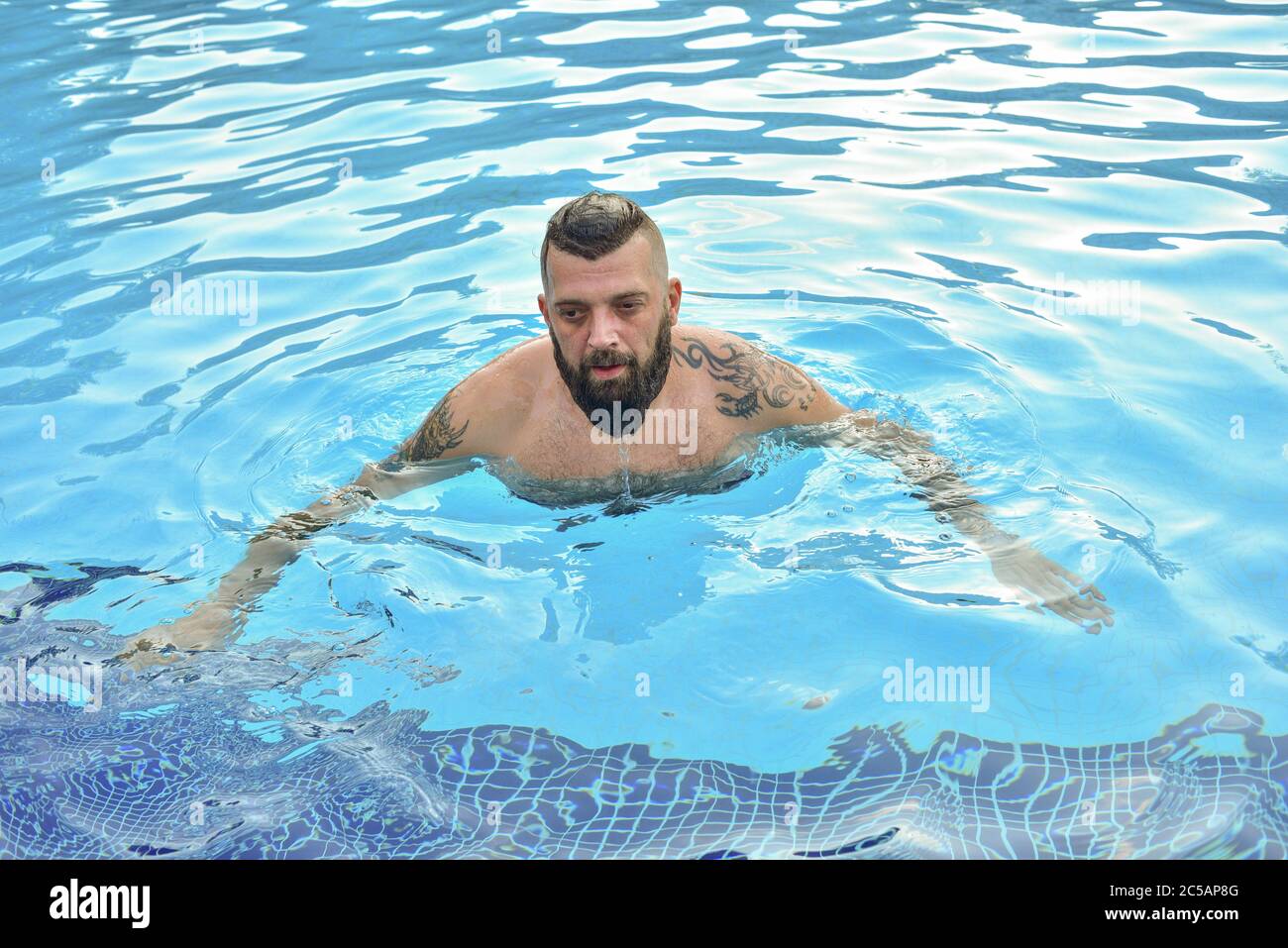 Bearded man swimming in a pool. Man with a beard in the pool Stock ...