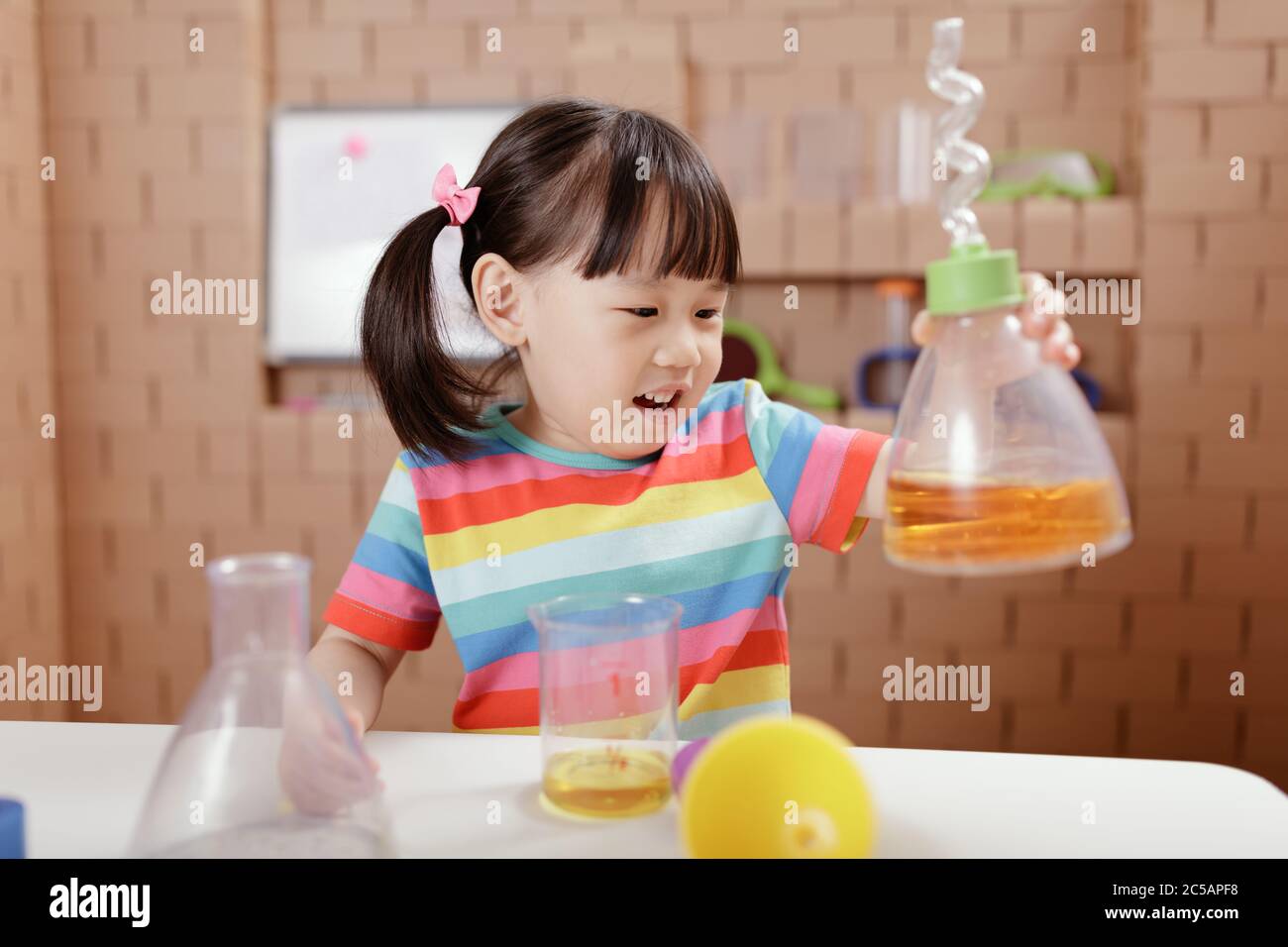 toddler girl play science experiments for homeschooling Stock Photo - Alamy