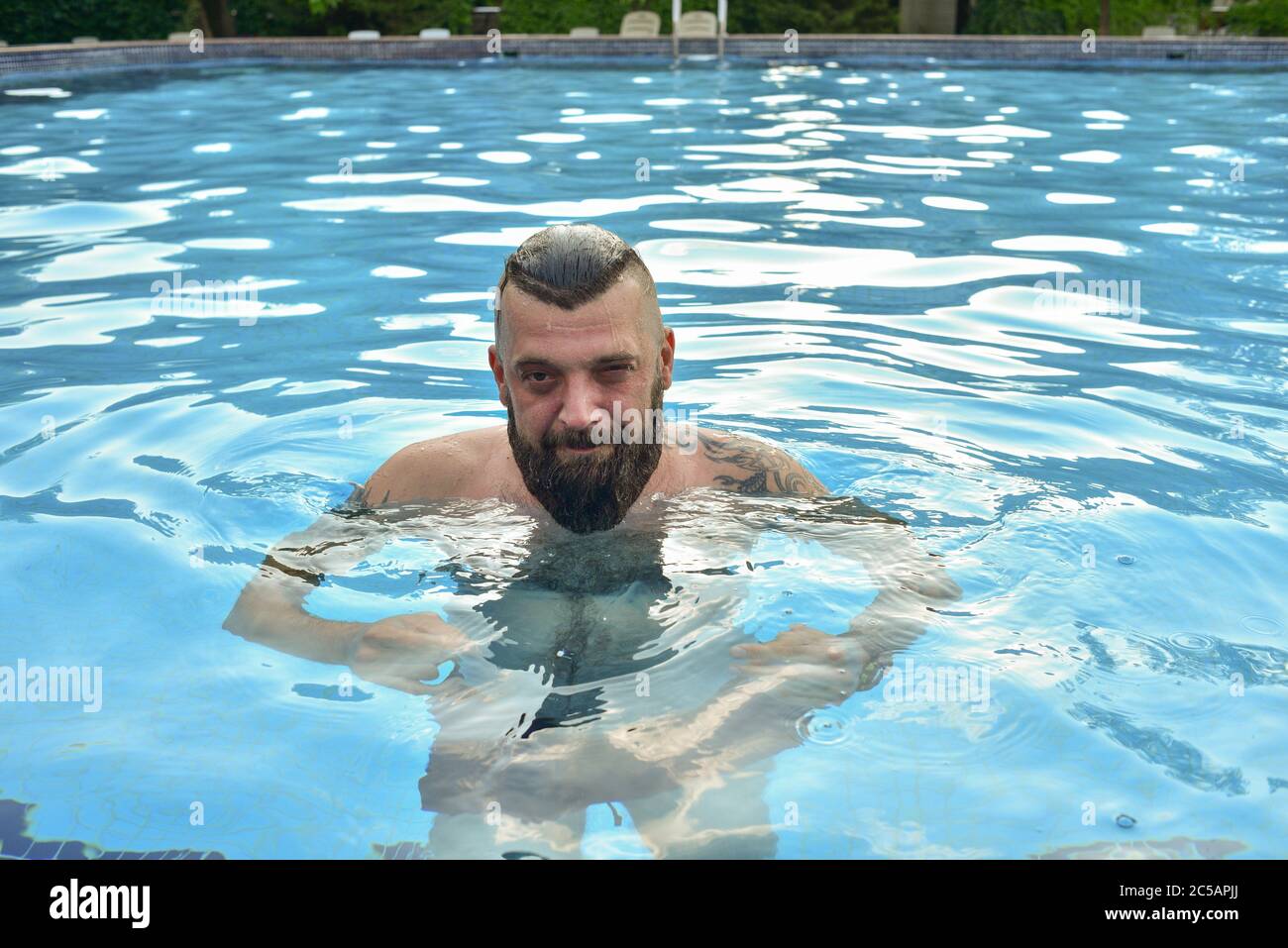 Bearded man swimming in a pool. Man with a beard in the pool Stock ...