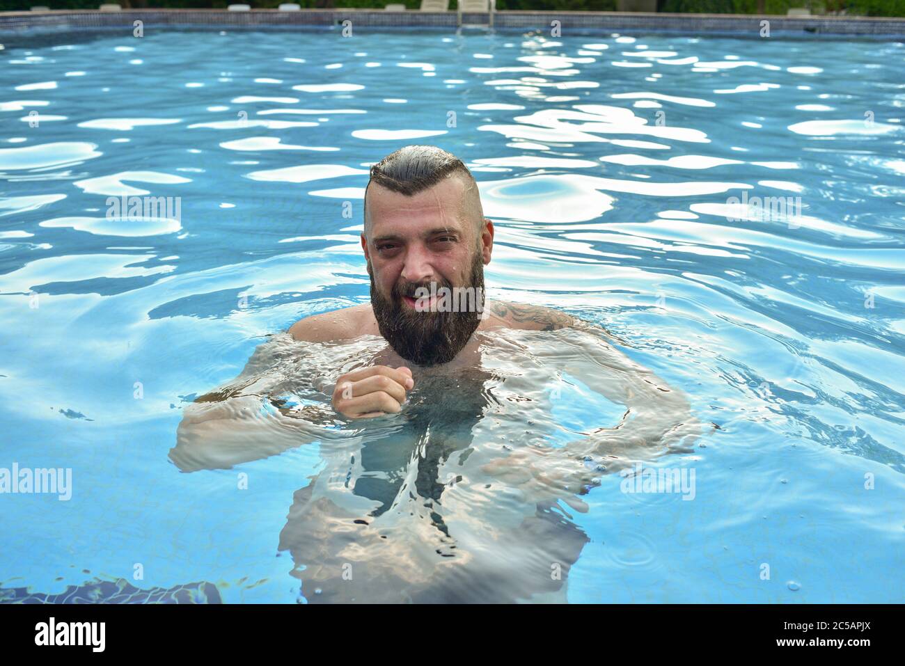 Bearded man swimming in a pool. Man with a beard in the pool Stock ...