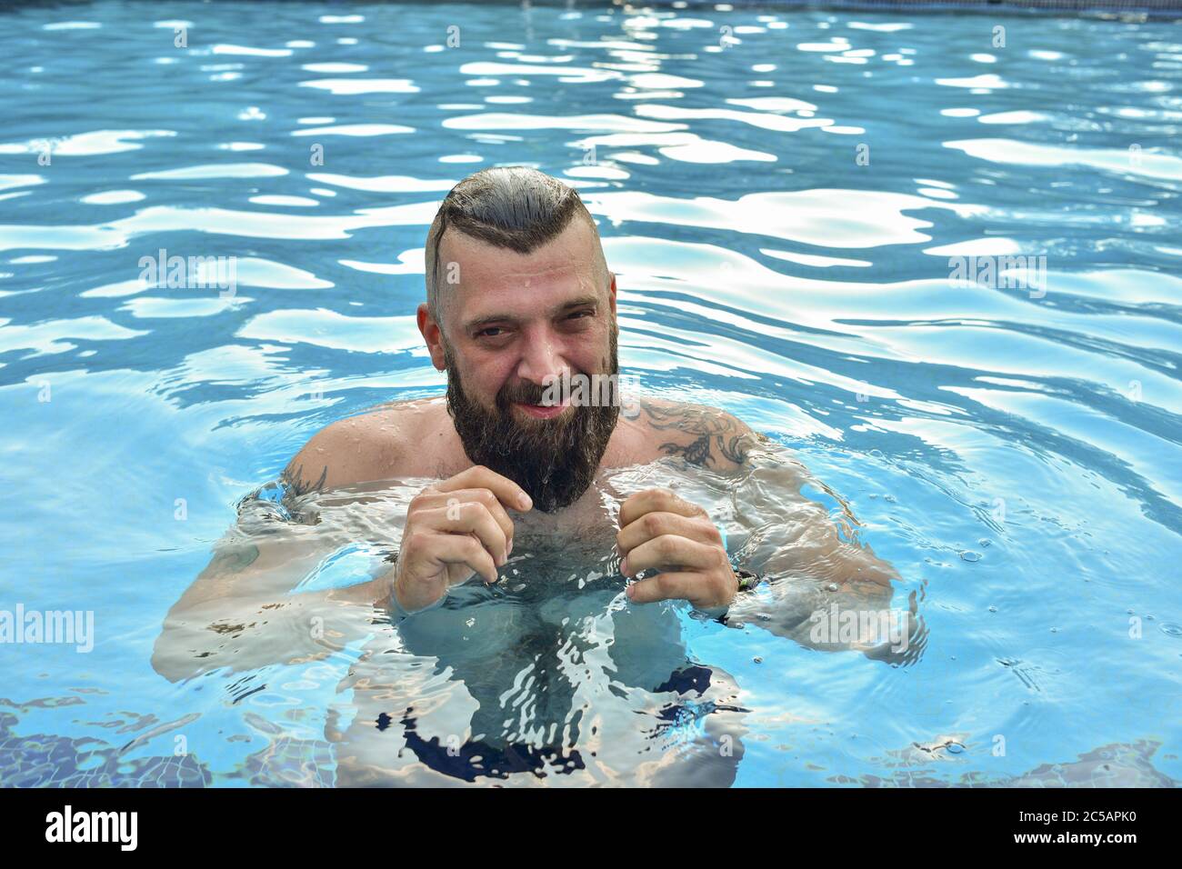 Bearded man swimming in a pool. Man with a beard in the pool Stock ...