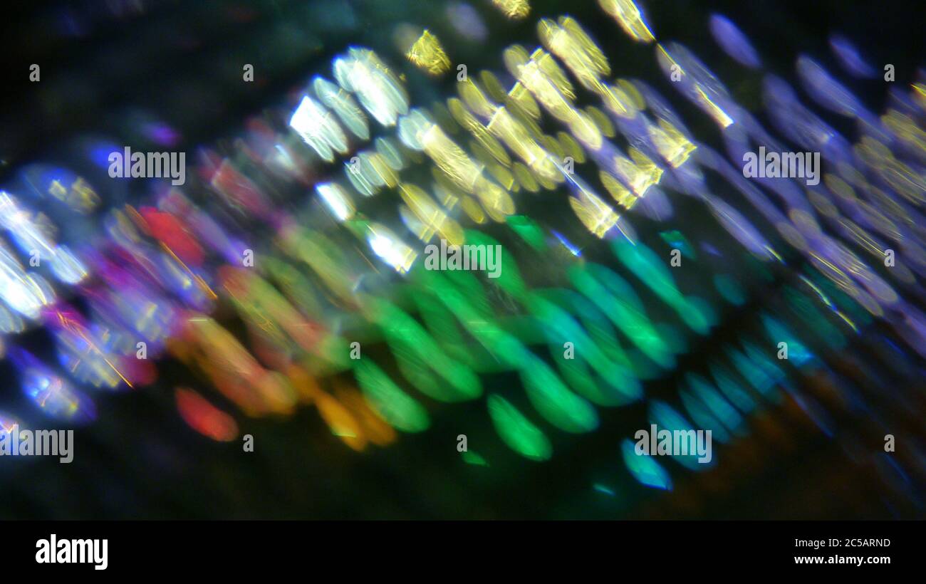 Beautiful shot of staggered and refracted colorful light layers on dark ...