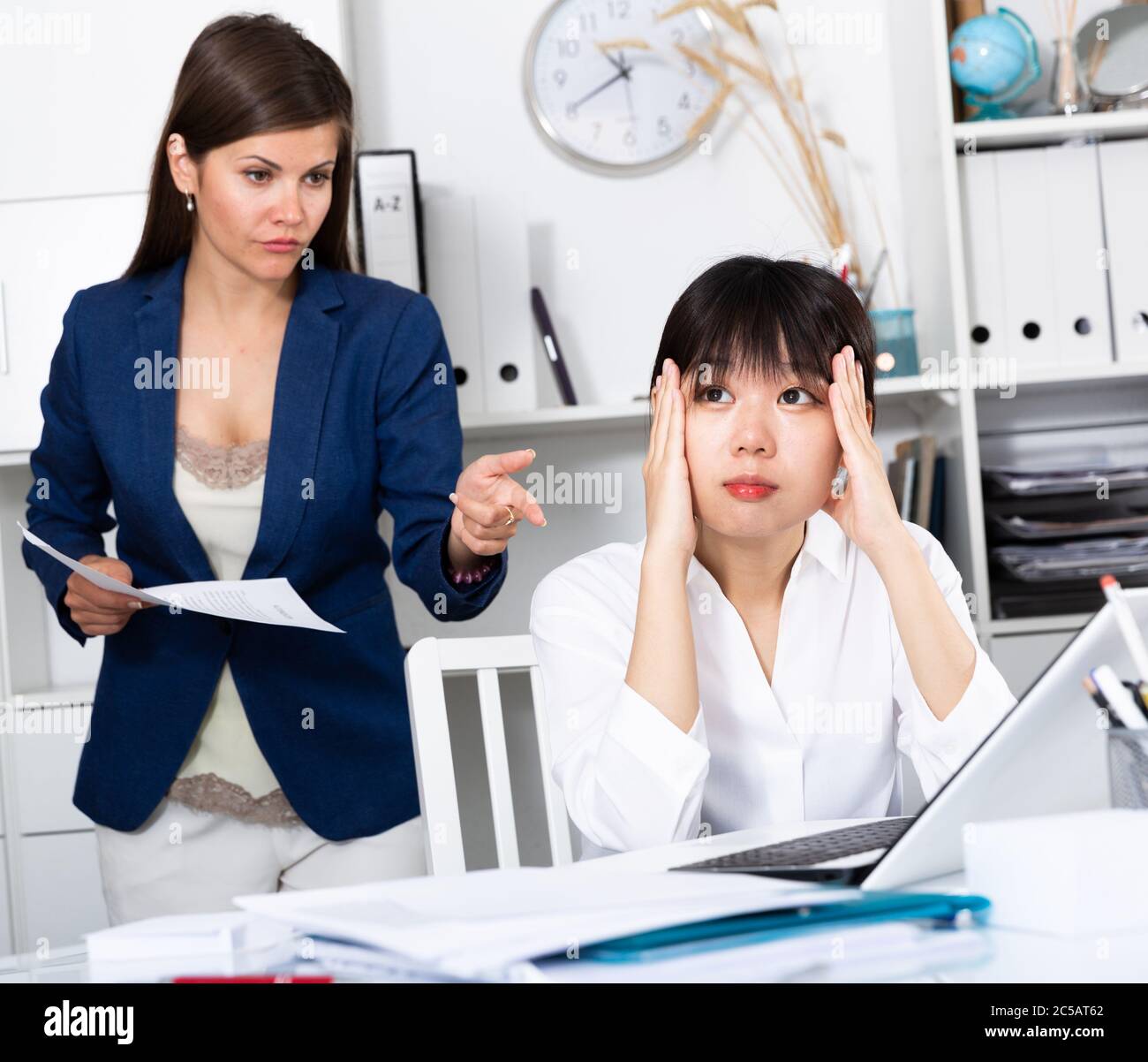 Angry boss screaming to young female manager during working Stock Photo ...
