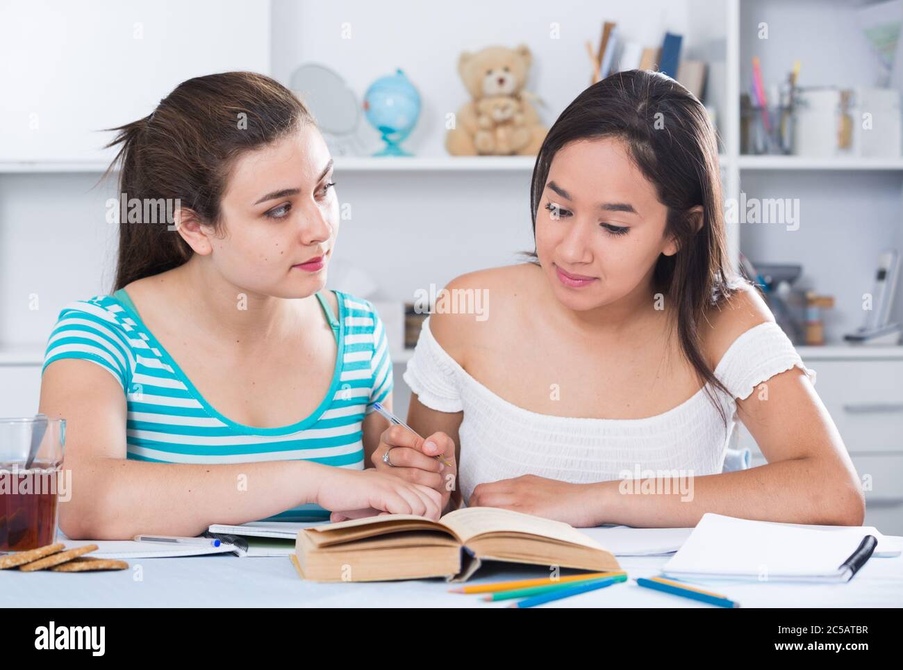 Two girls classmates sitting hi-res stock photography and images - Alamy
