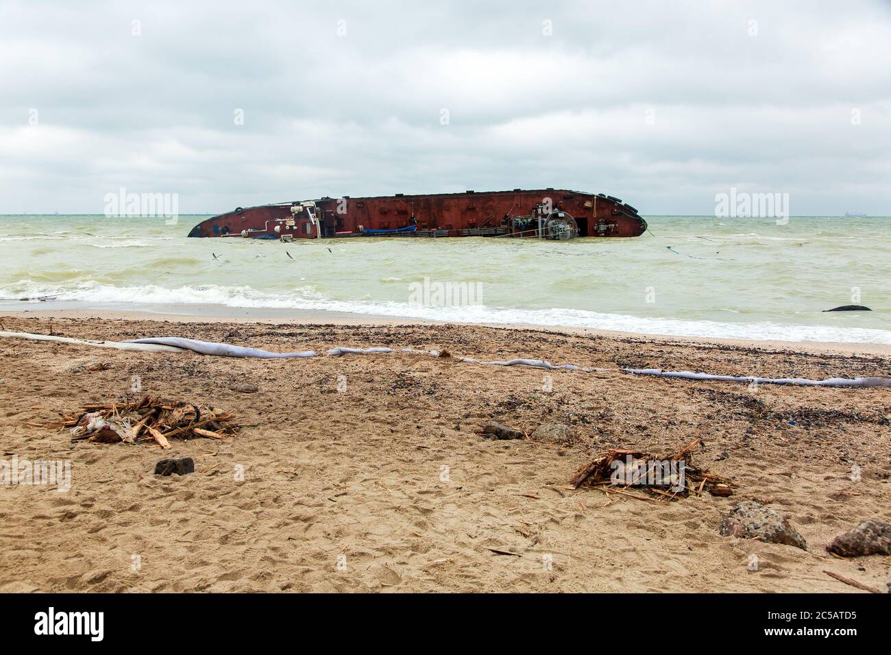 dirty sandy beach in the remnants of garbage after the ship wreck near ...