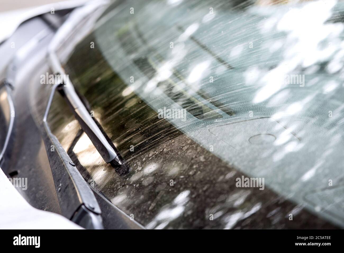 windshield with wipers of a dirty car in dust and smeared with swamp ...