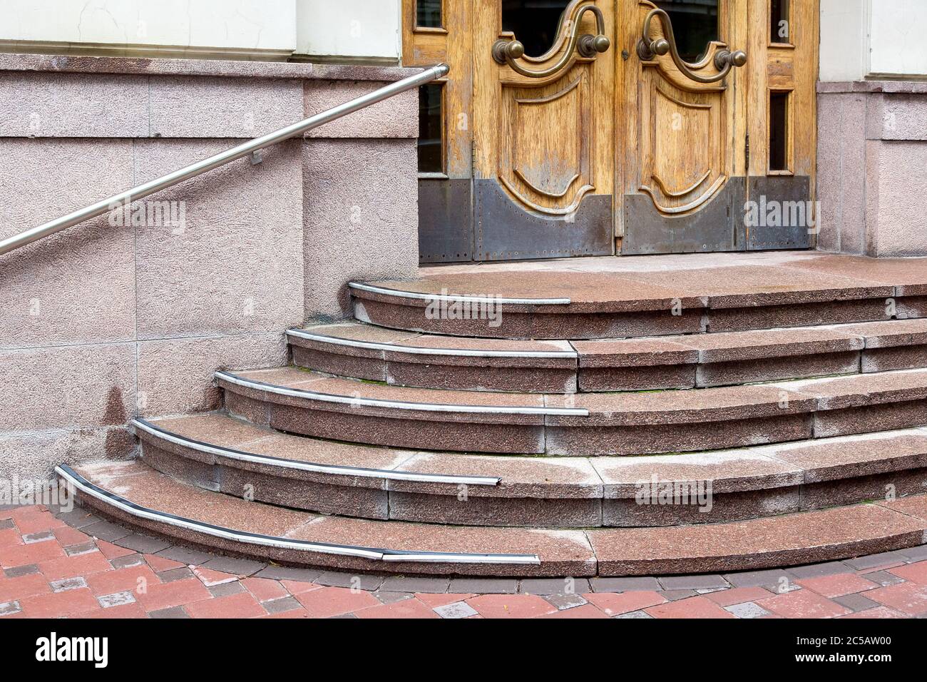 granite staircase with a rise to the wooden entrance door, threshold ...
