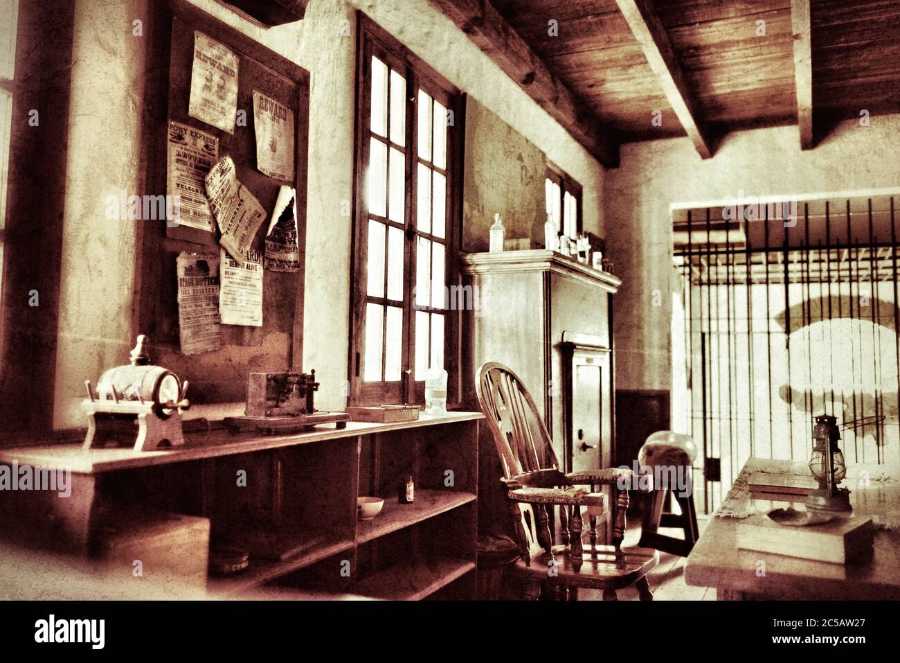 Vintage sheriff office. Desk with kerosene lamp and chair, strongbox on ...