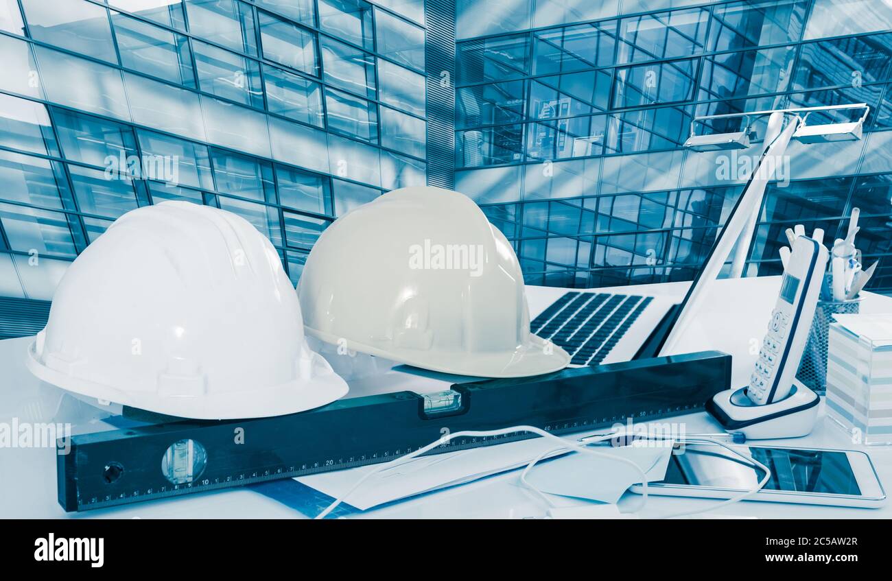 Engineering tools on office desk on background with large factory Stock ...