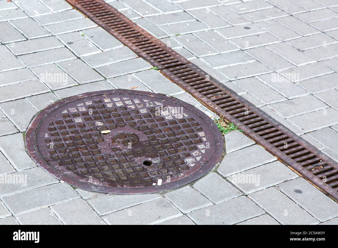 A round manhole and lattice of a drainage paving system on a area made ...