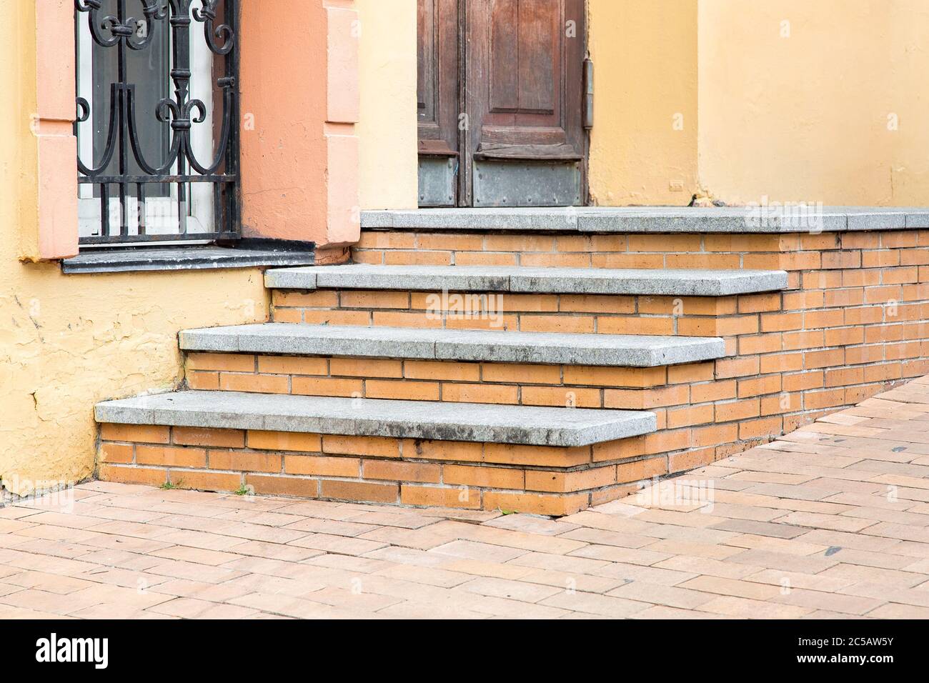 brick threshold with granite steps to the old wooden entrance door ...