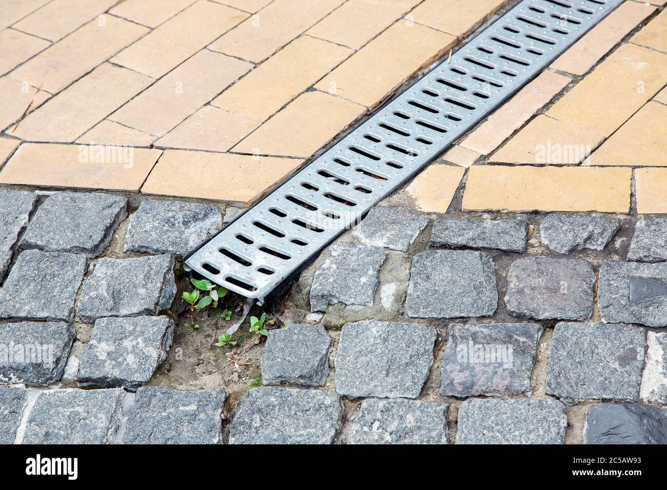 A stainless steel lattice of a drainage paving system on a walkway made ...