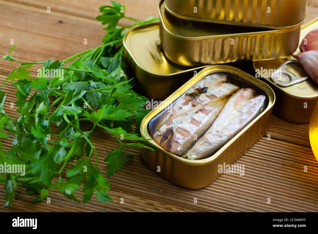 Preserved seafood, open can of tinned mackerel fish with condiments on ...
