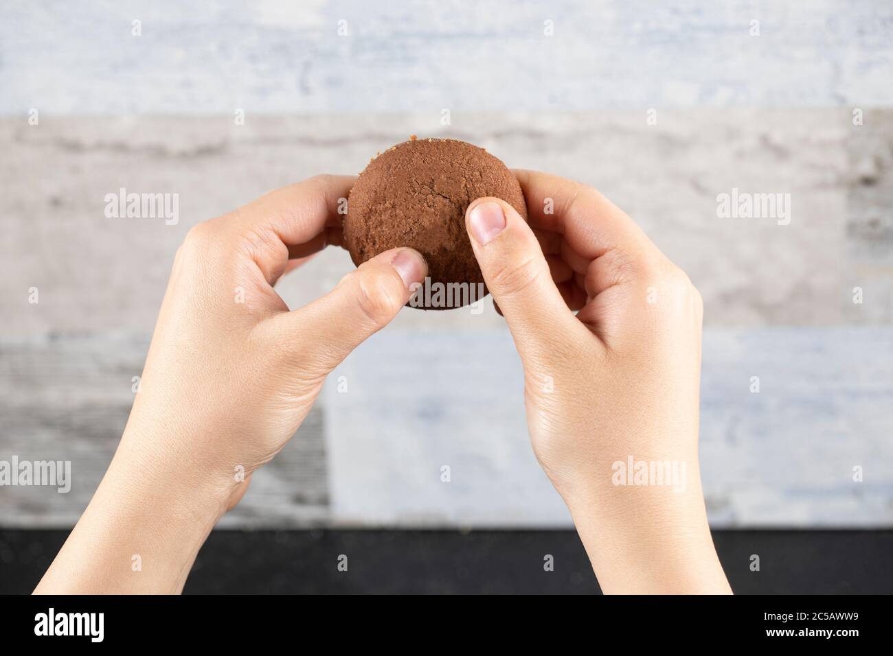 Cocoa biscuit in the hand Stock Photo - Alamy