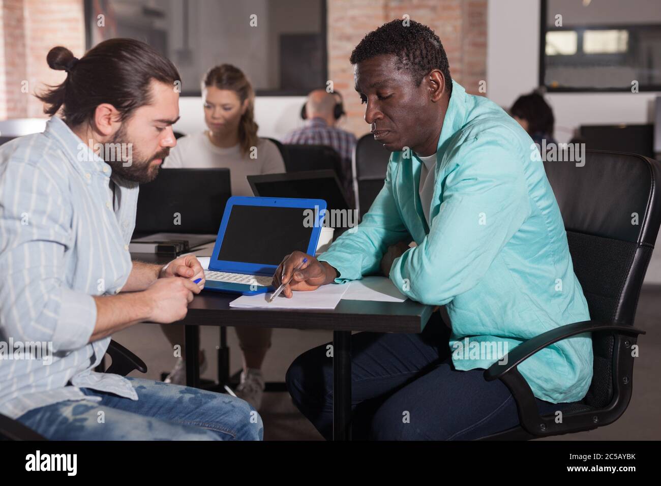 Multiracial partners developing business strategy talking at office ...