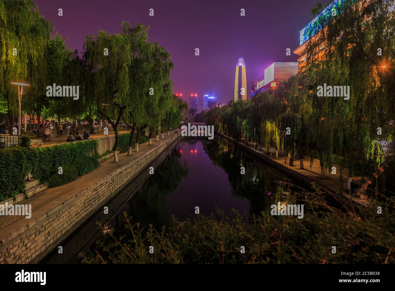 View over water channel of Boatu Spring in Jinan at night in summer ...