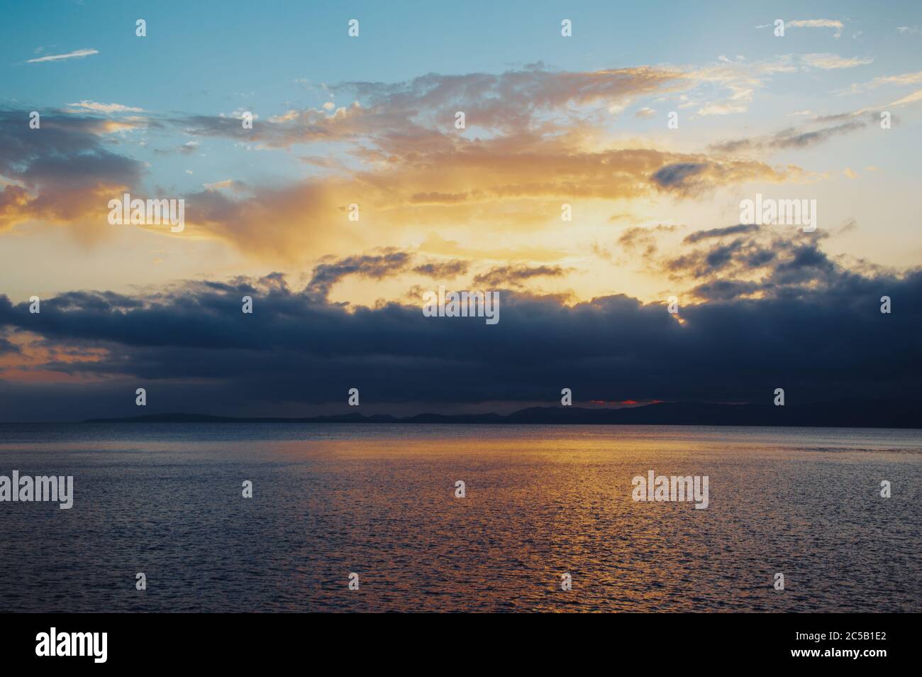 Sunset in the sky over the still water Stock Photo - Alamy