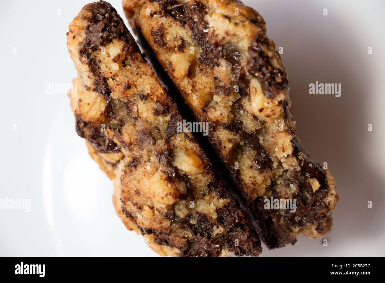 Closeup of the inside of two chocolate oatmeal cookie pieces on a white ...