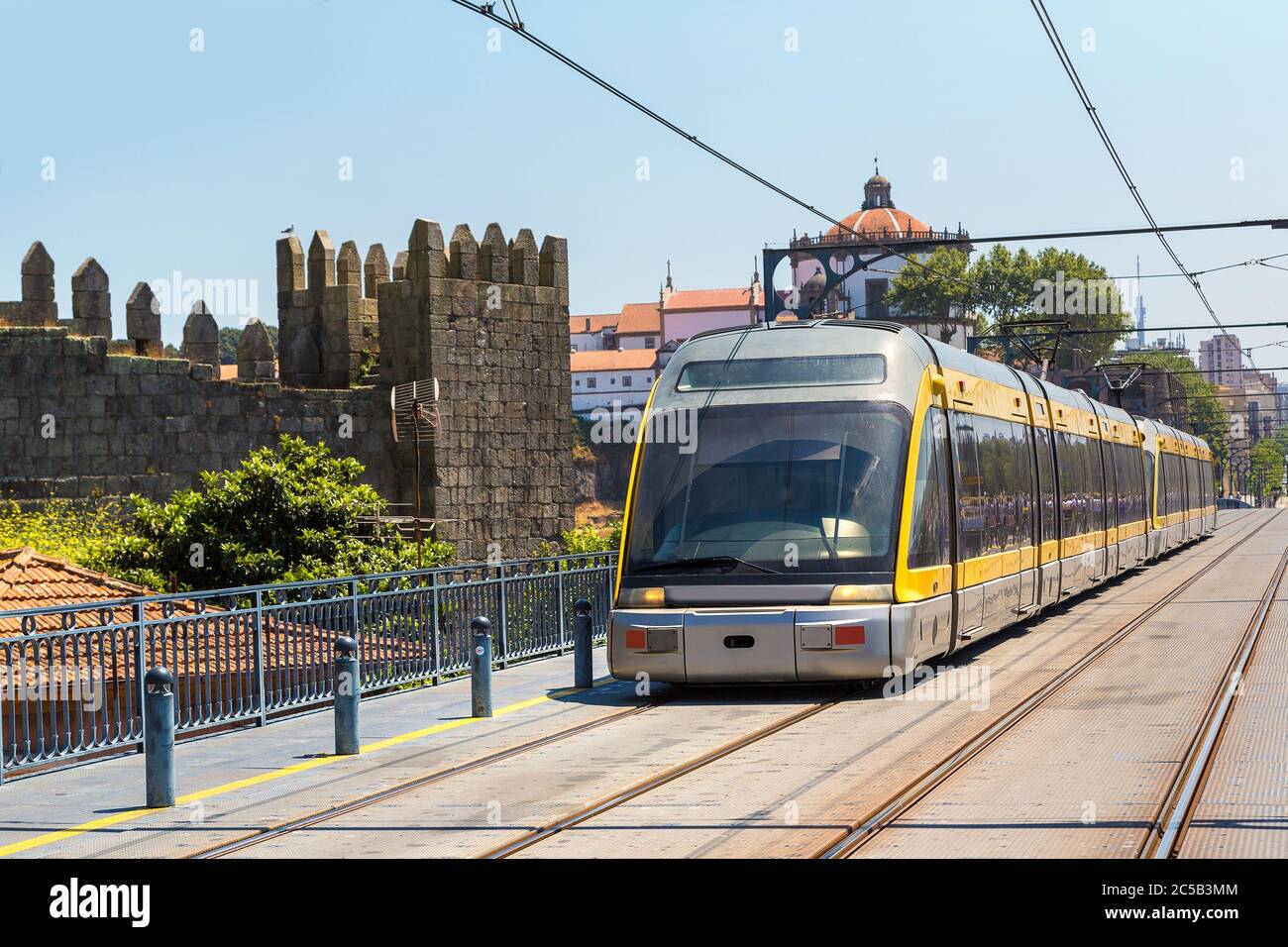 Modern metro train on the bridge in Porto in a beautiful summer day ...