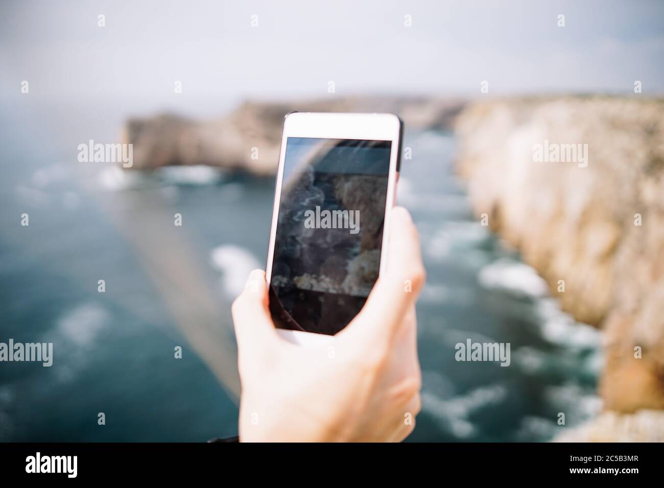 Horizontal shot of a person taking photo on a phone of a beautiful ...