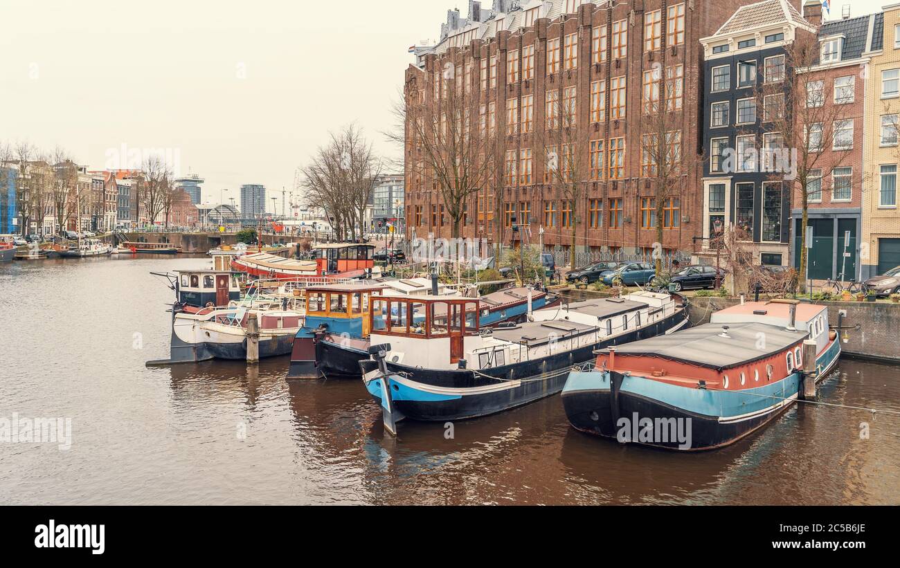 Typical floating house at Amsterdam water canal in historical center ...