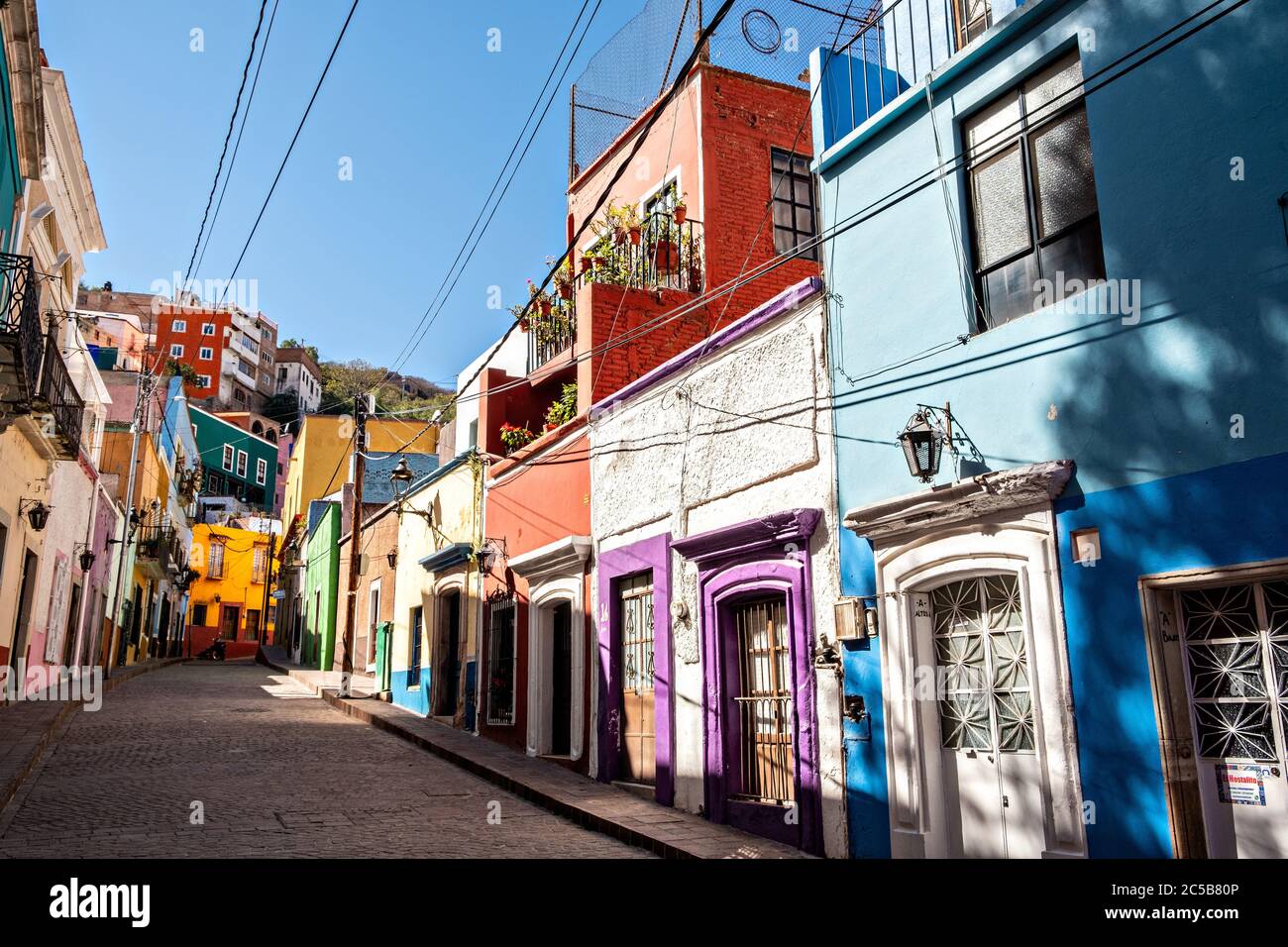 View of the colorful buildings a cobblestone street in the historic ...