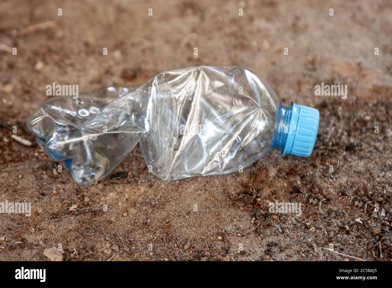 A plastic bottle is lying on the ground. Environmental pollution ...