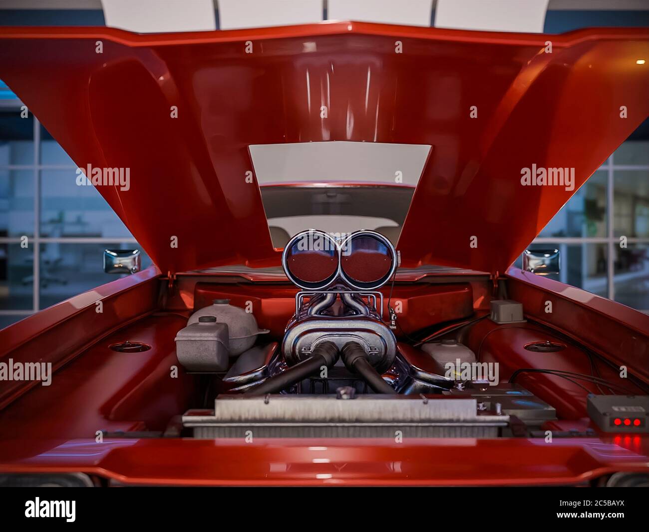 muscle car on exhibition center with hood open showing the motor , 3d ...