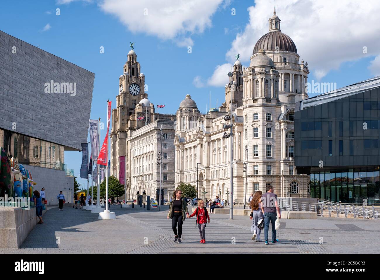 Street scene in Liverpool with a view of the historic Three Graces ...