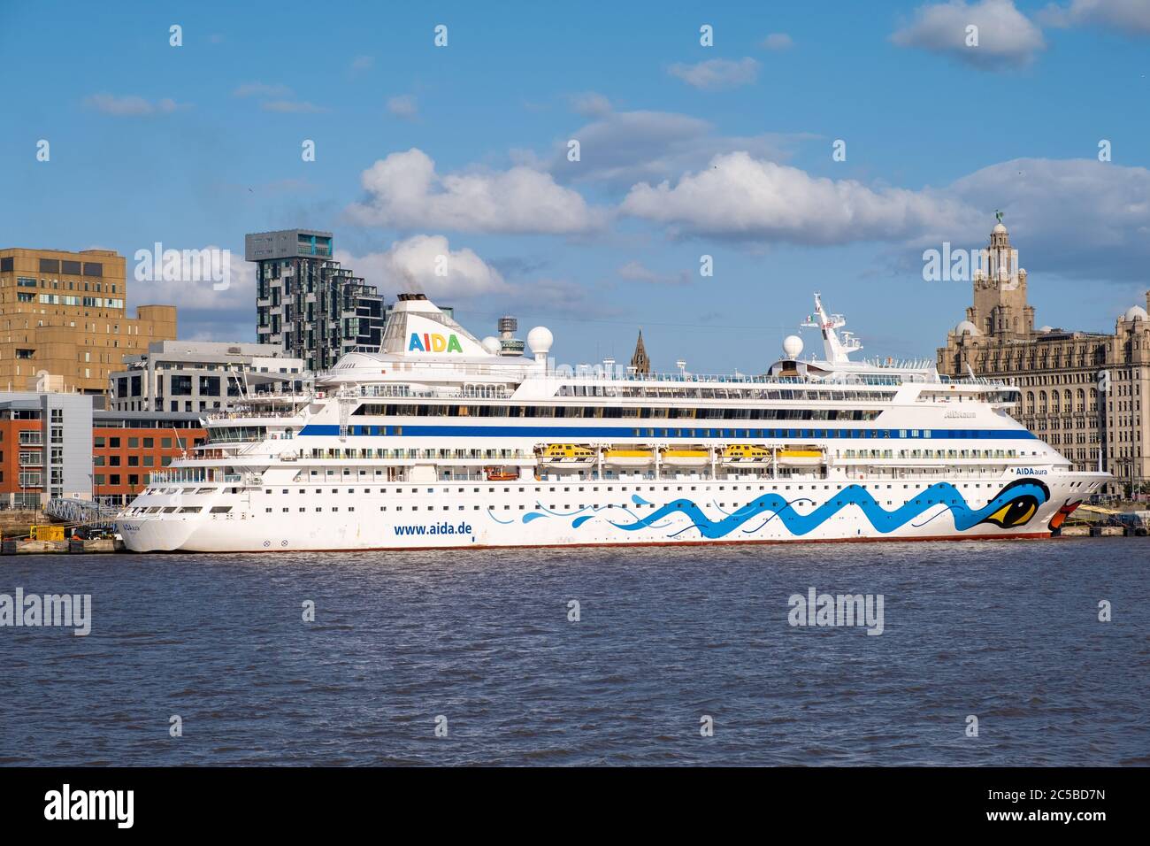 Cruiser ship docked at the Port of Loverpool with a view of the iconic ...