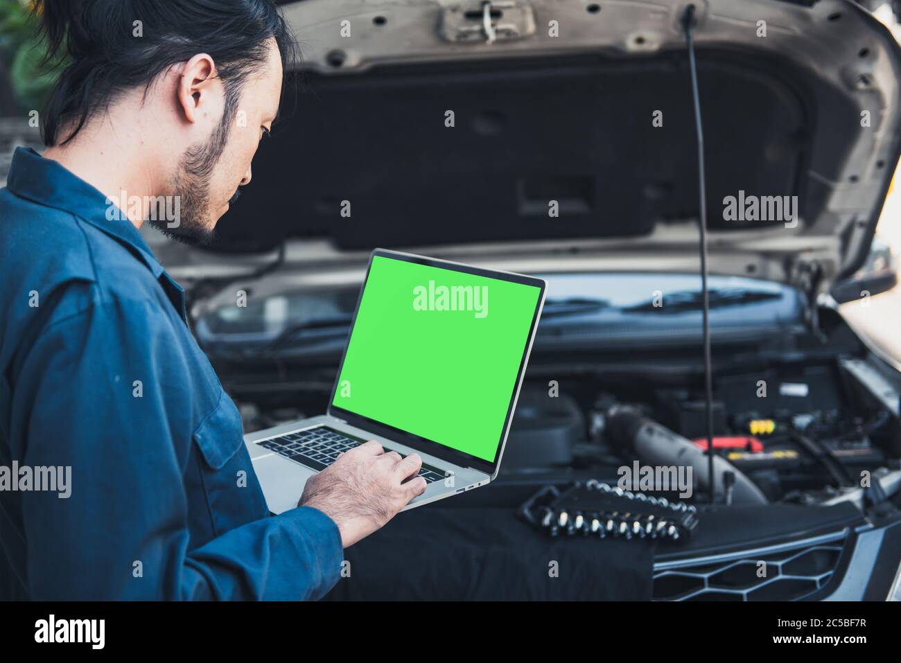 Mechanic Engineer is Diagnosing Car Engine and Electric Adjusting ...