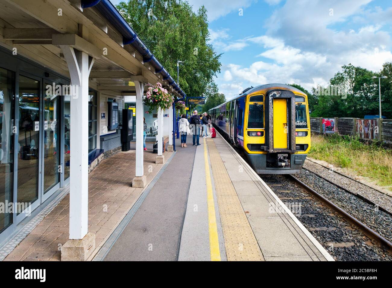 A train arrives at the Windermere train station on the Lake District ...