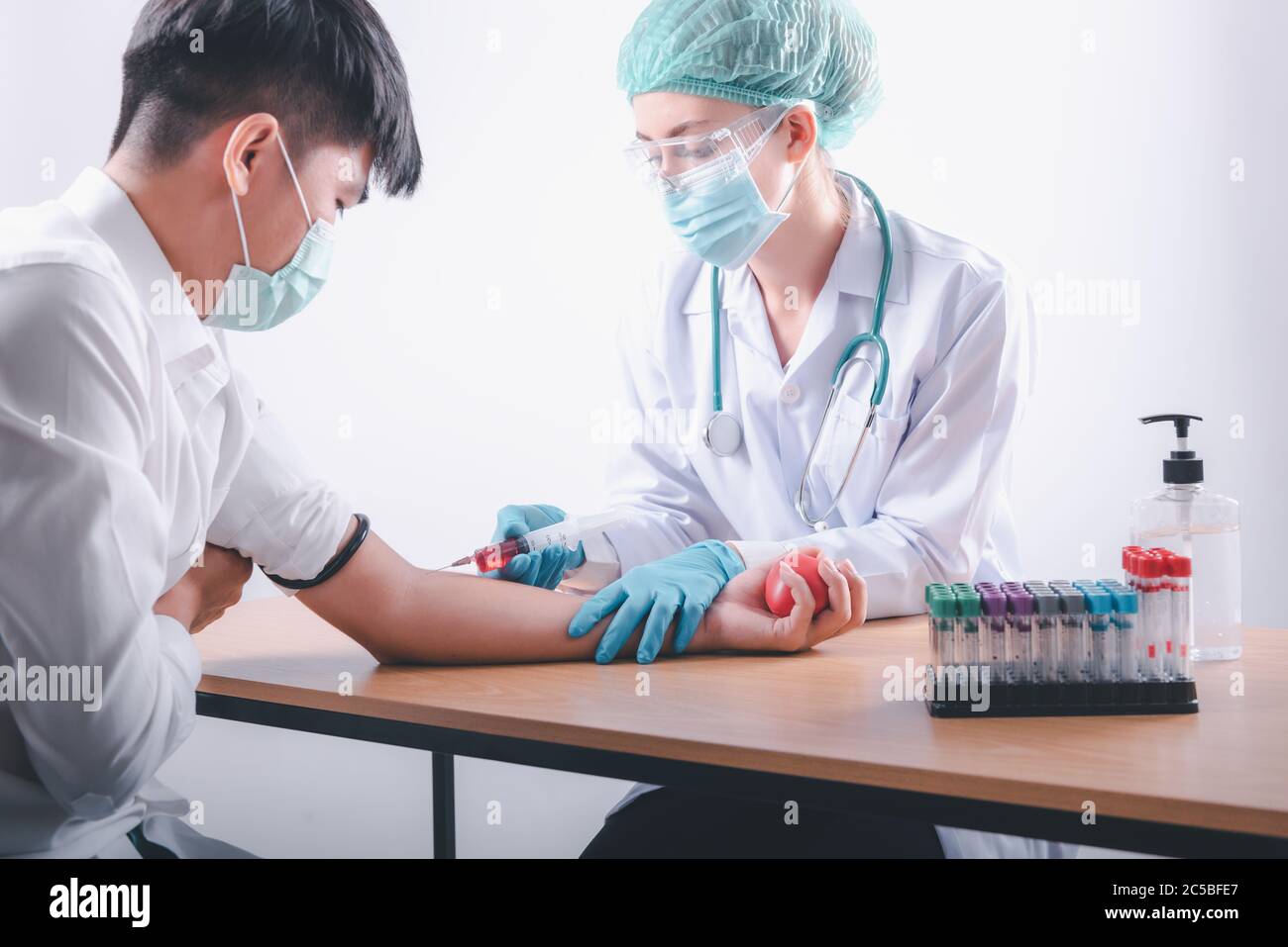 Medical Doctor is Collecting Blood Sample Test Syringe Injection From ...