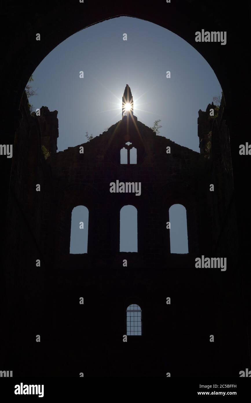 Plants grow atop the stone walls of this ruined cathedral, and sun ...