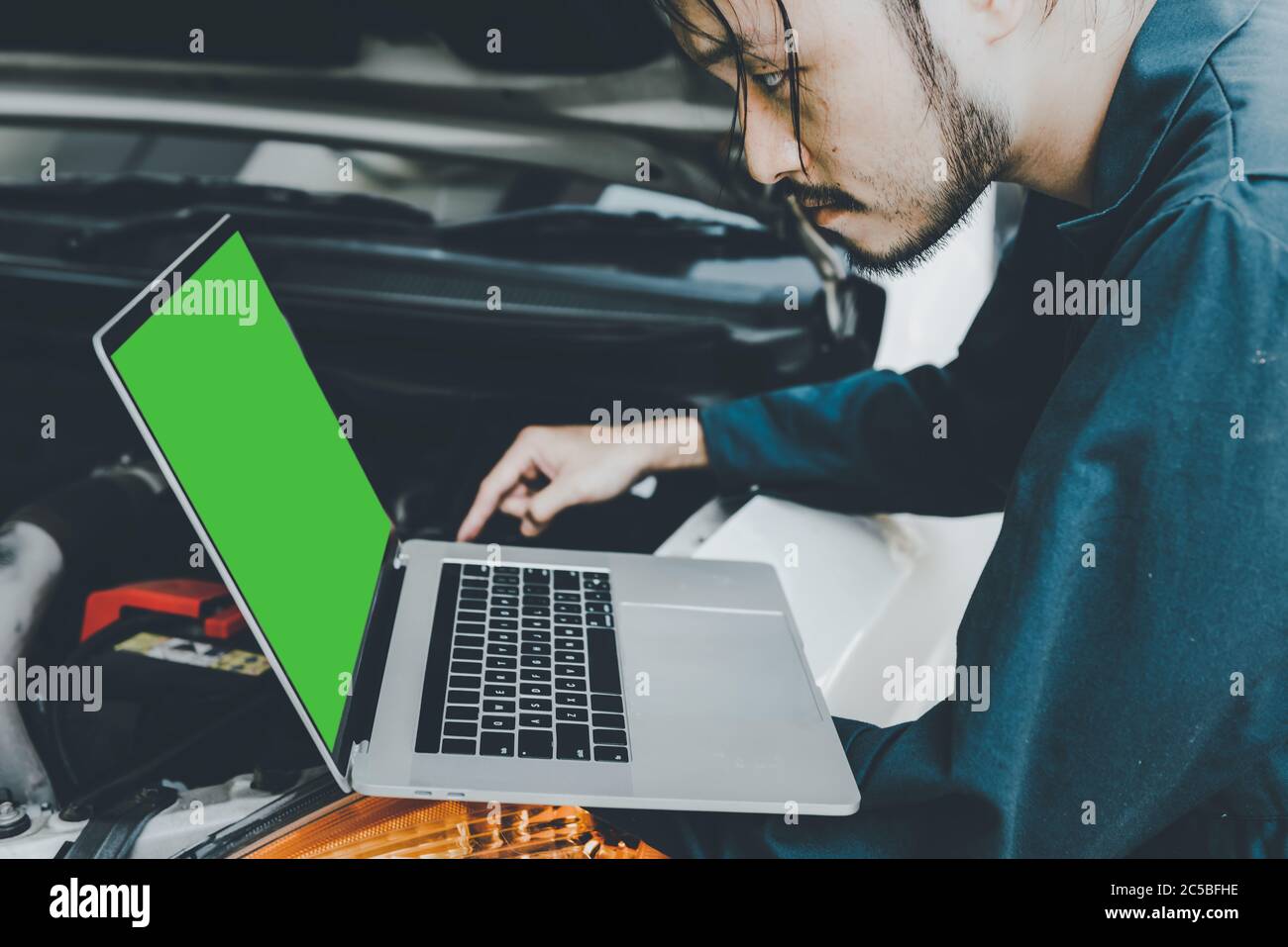 Mechanic Engineer is Diagnosing Car Engine and Electric Adjusting ...