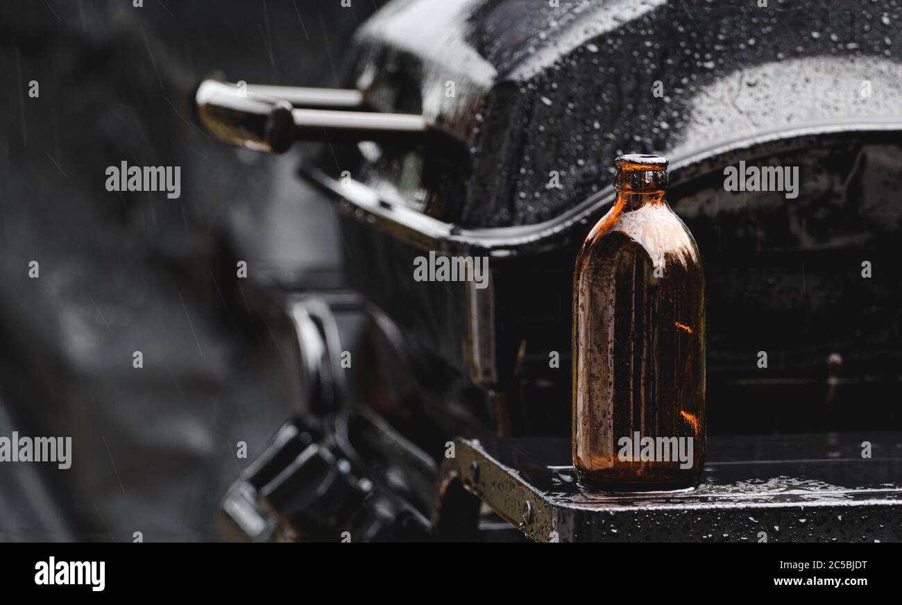 Stubby beer bottle and barbecue in the pouring rain Stock Photo - Alamy
