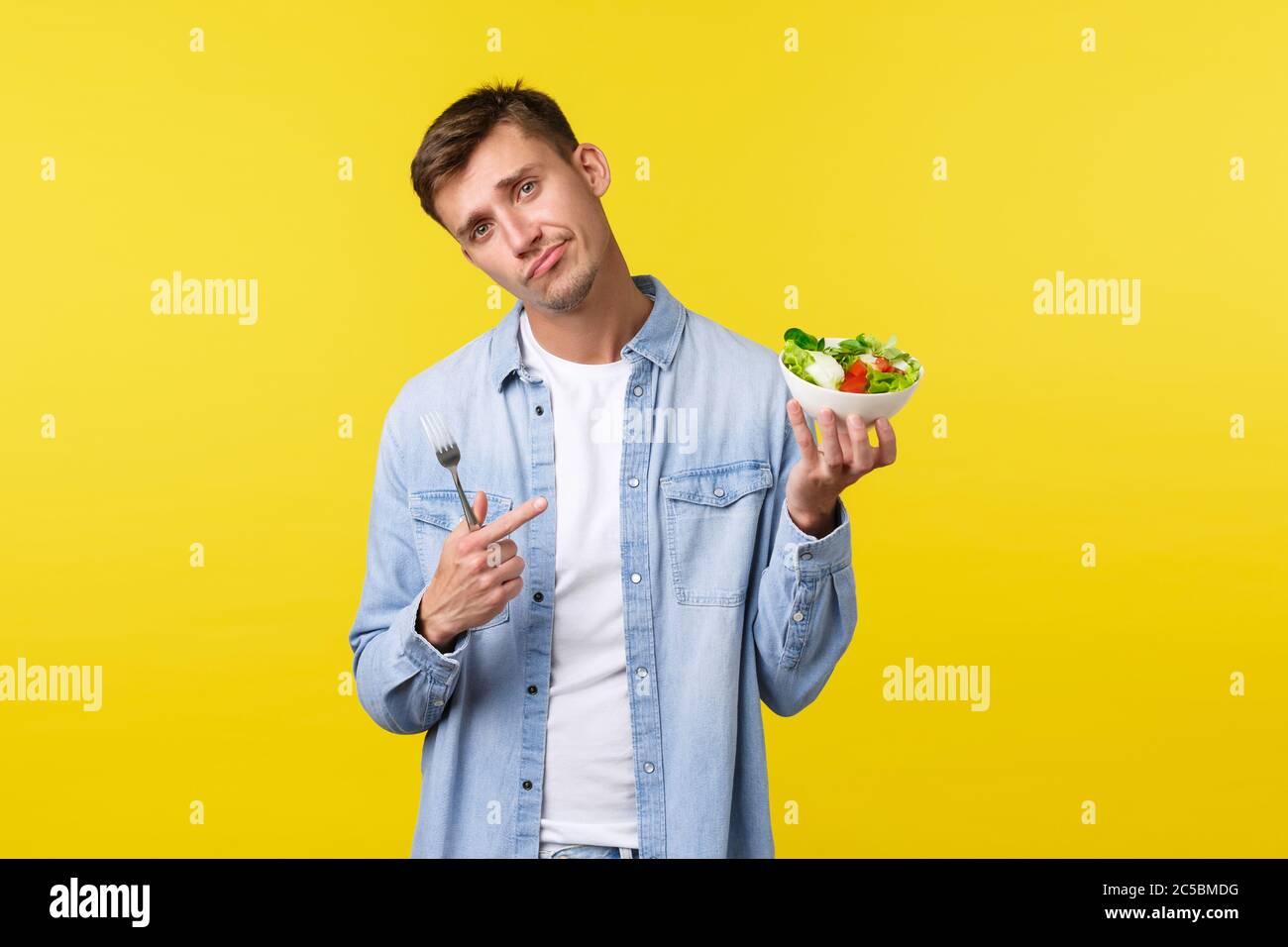 Healthy lifestyle, people and food concept. Reluctant handsome young ...